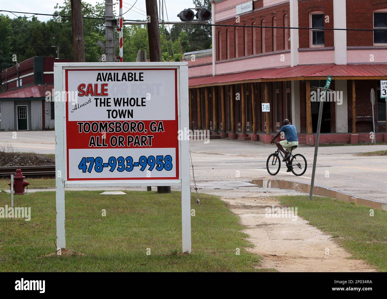 A resident rides down Main Street in Toomsboro, Georgia, on May 9, 2012 ...