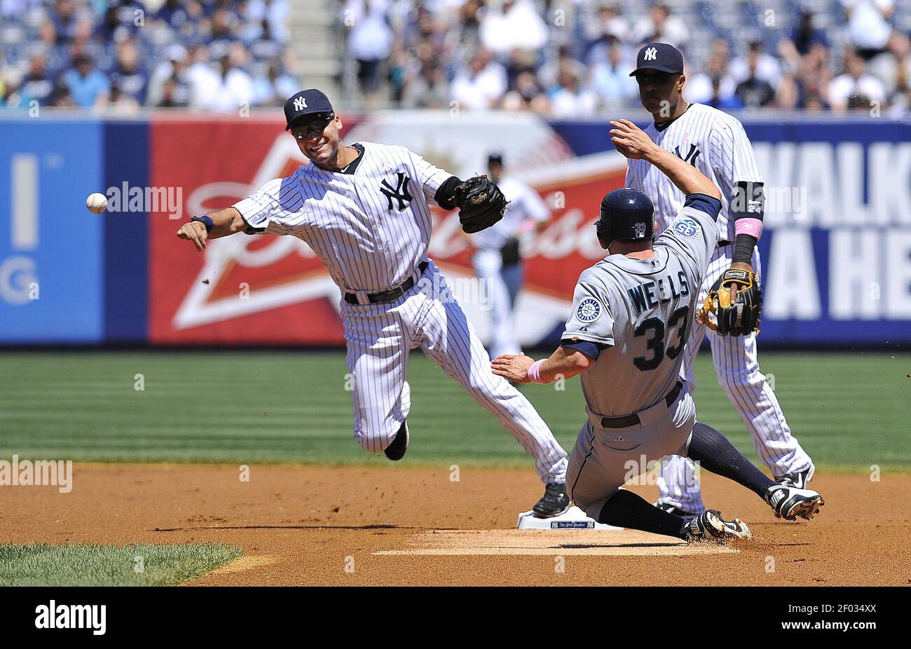 Derek Jeter of the New York Yankees touches second base to get out ...