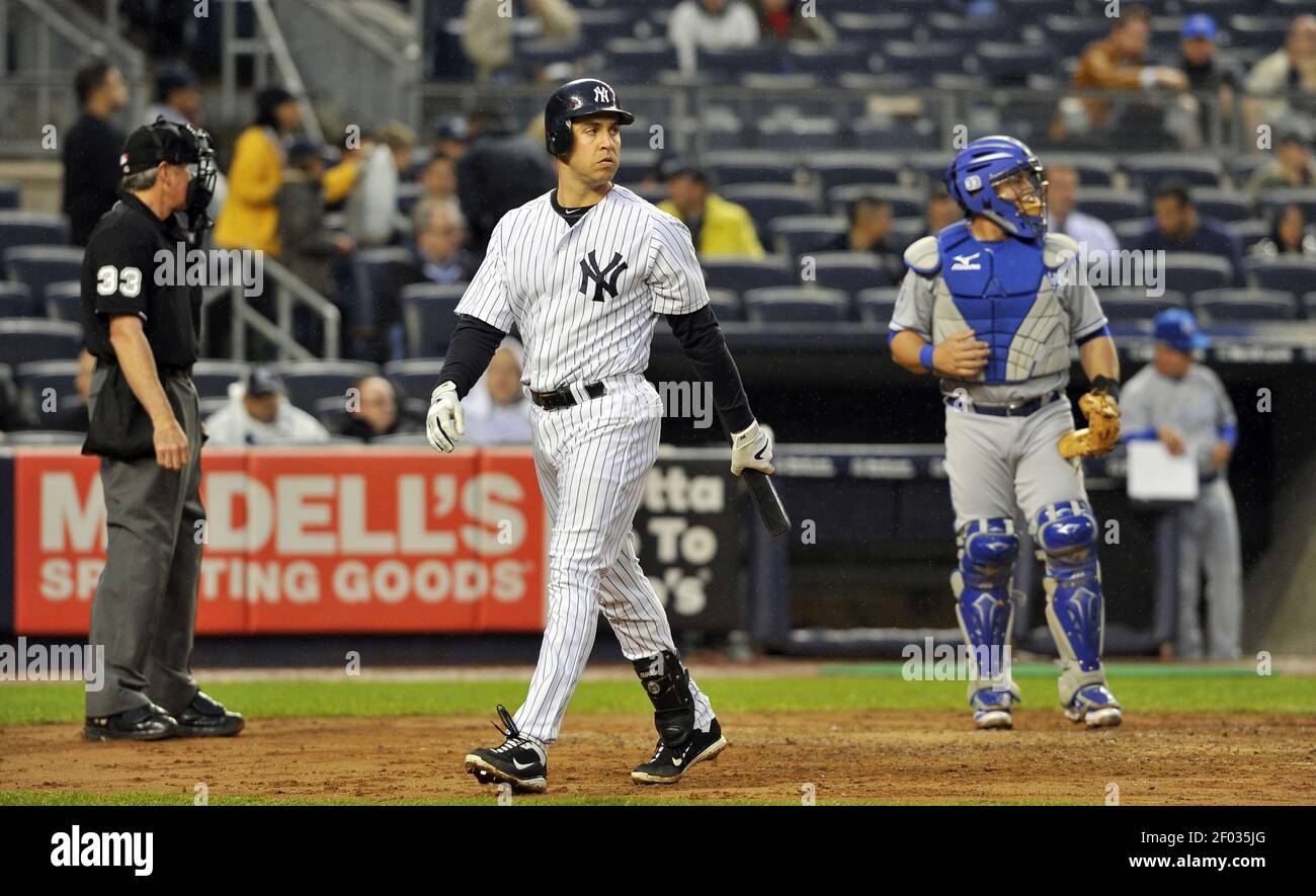 New York Yankees' Mark Teixeira walks back to the dugout after striking ...