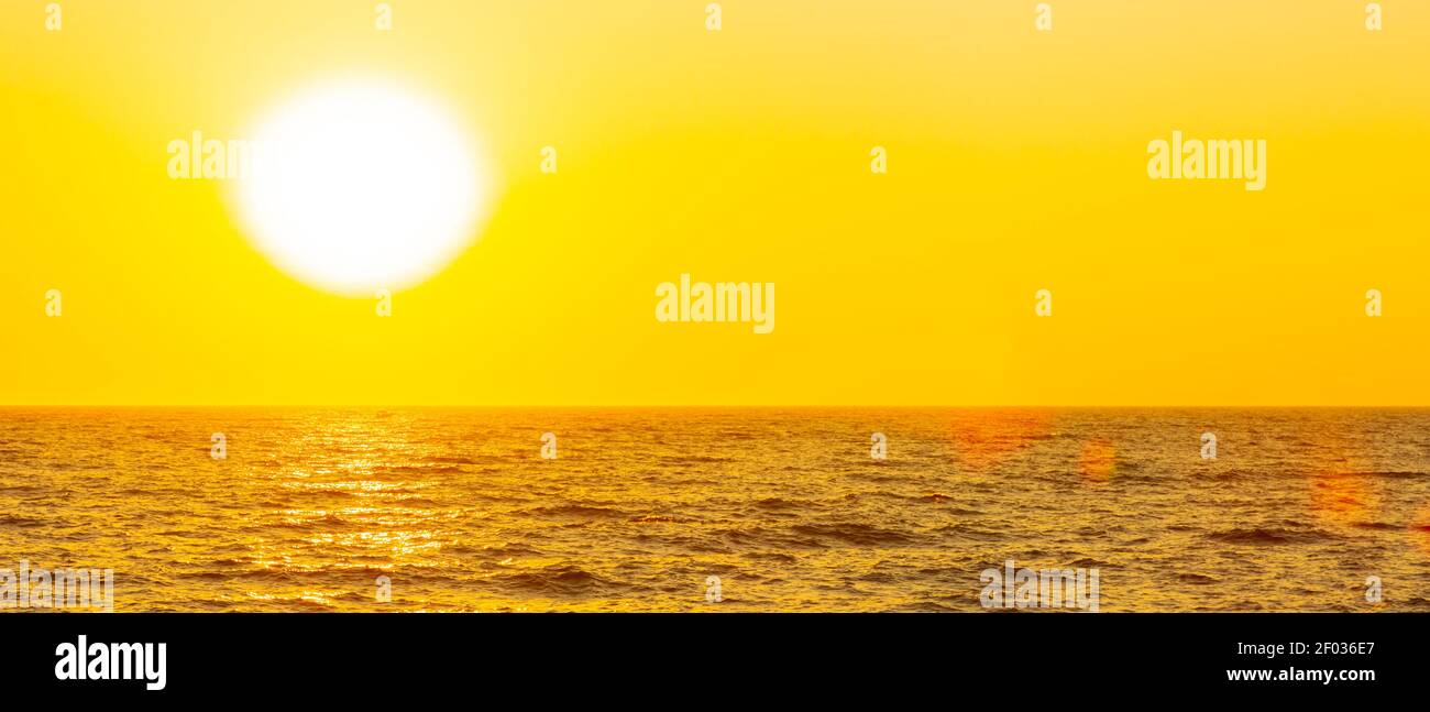 Orange sunset over sea. Bright sun over the sea horizon. Concept ...
