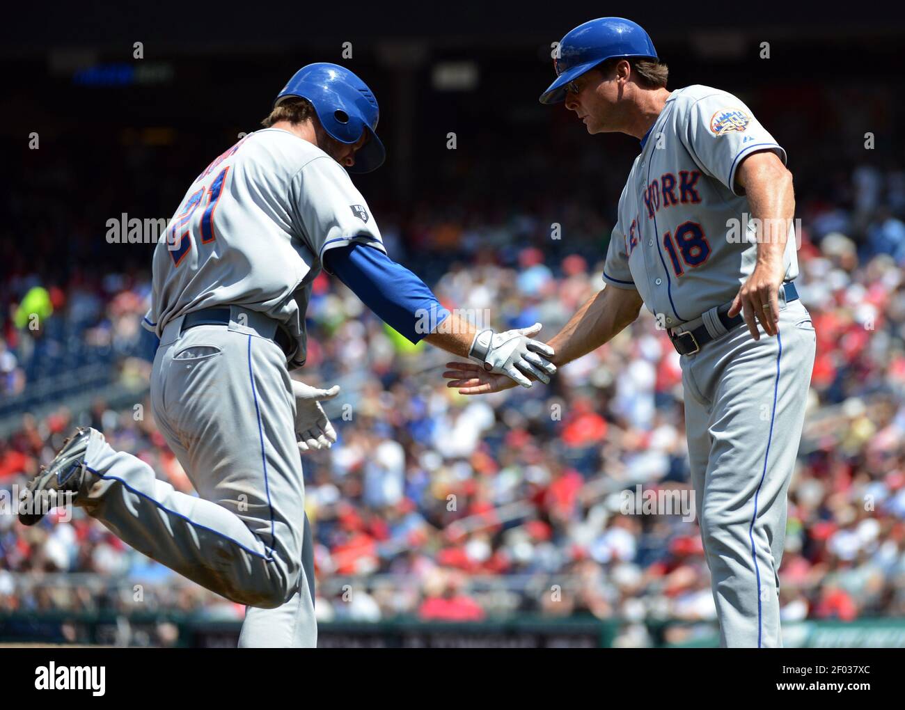 New York Mets third base coach Tim Teufel (18) congratulates New York ...