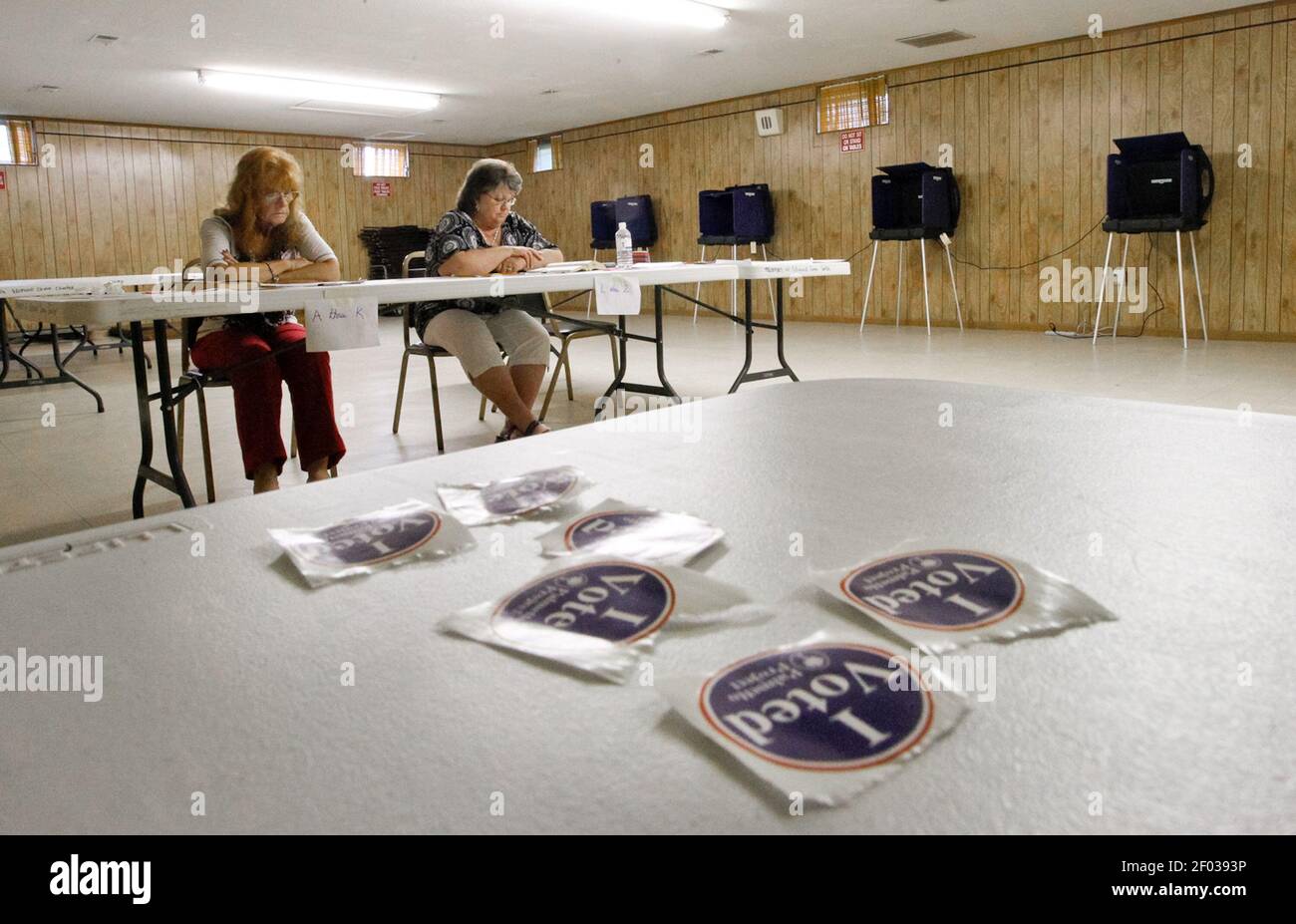 Martha Cooper, left, and Carole Belford read as they wait for voters in ...