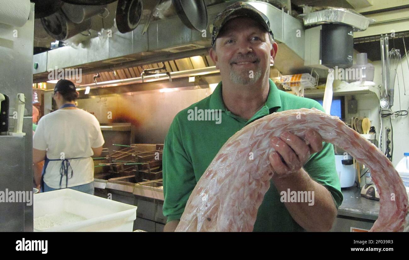 Ron McFarlain, owner of Cajun Connection in North Utica, Illinois, hols ...