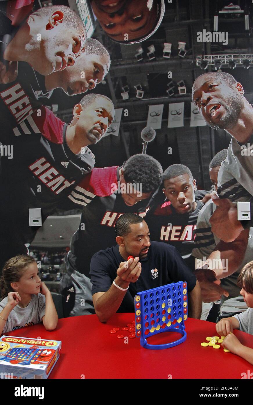 Alexa Garcia, 7, watches as Juwan Howard, center, plays a game of ...