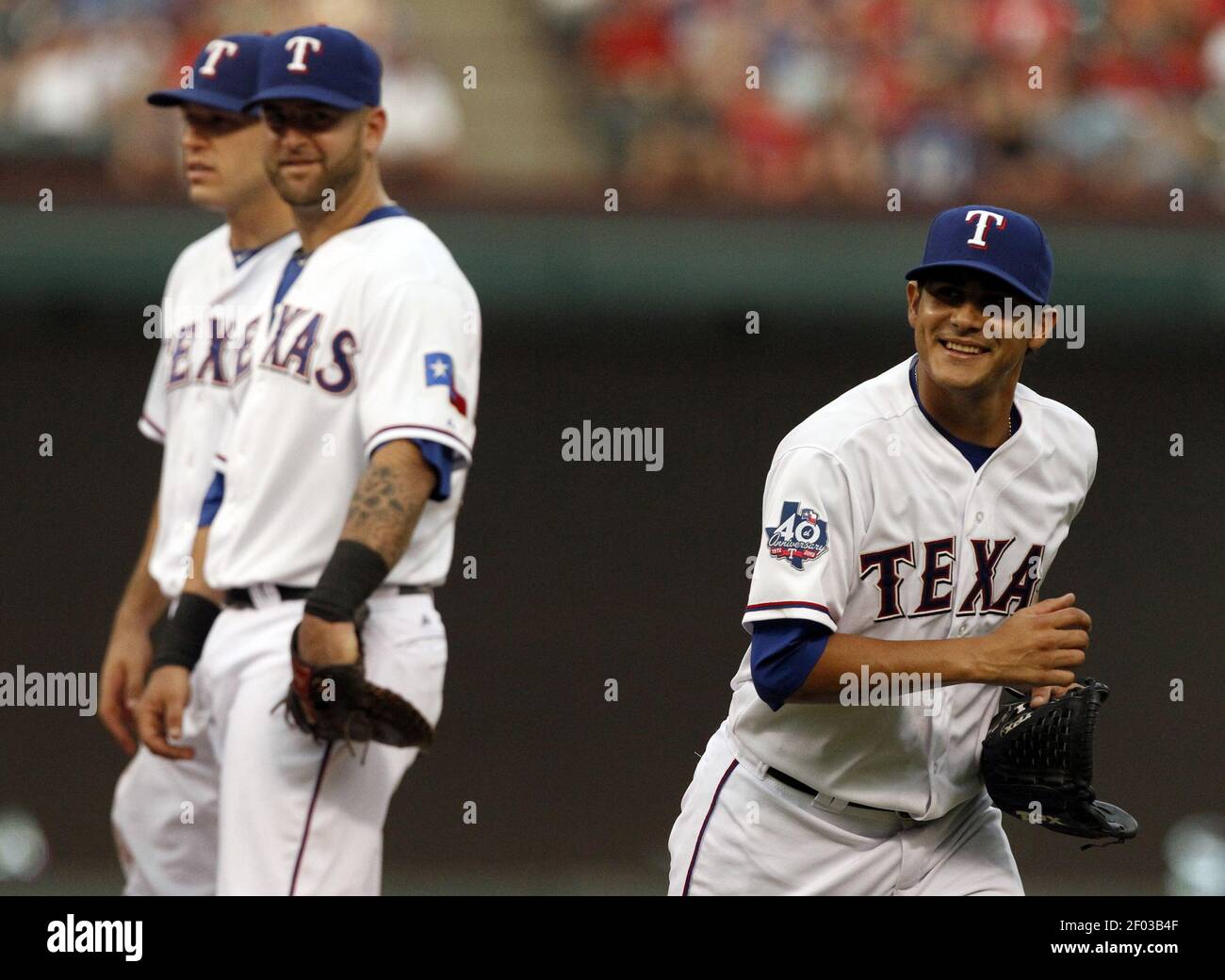 Texas Rangers starting pitcher Martin Perez, right, smiles as he leaves ...