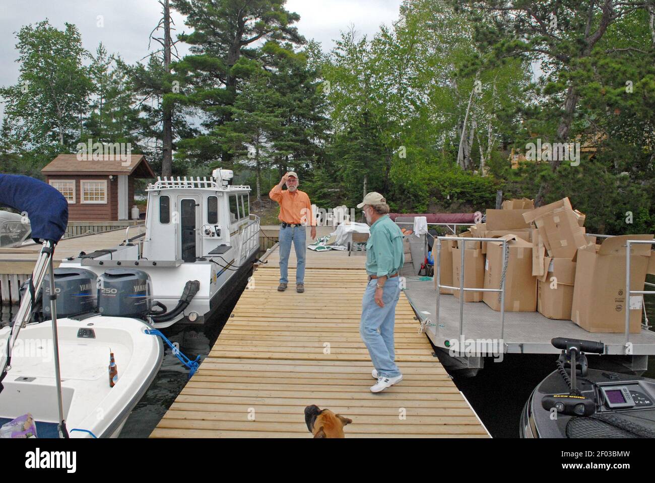 Bud Burger, left, and his twin brother, Ted, stand on the dock of the ...