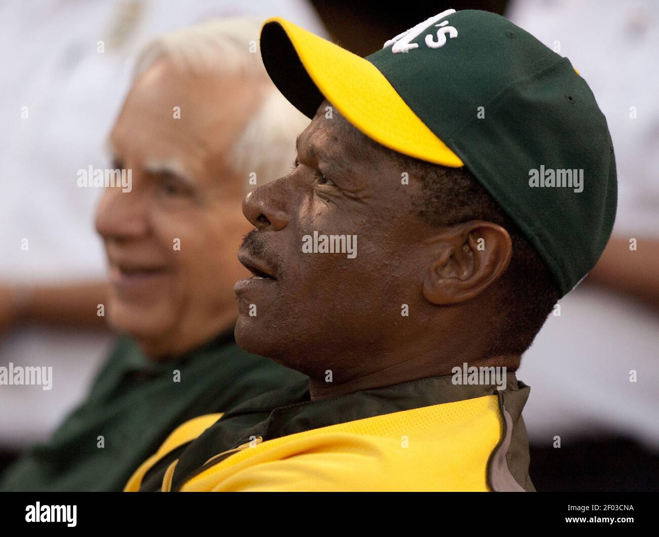 Oakland Athletics Hall of Famer Rickey Henderson, right, sits with team ...