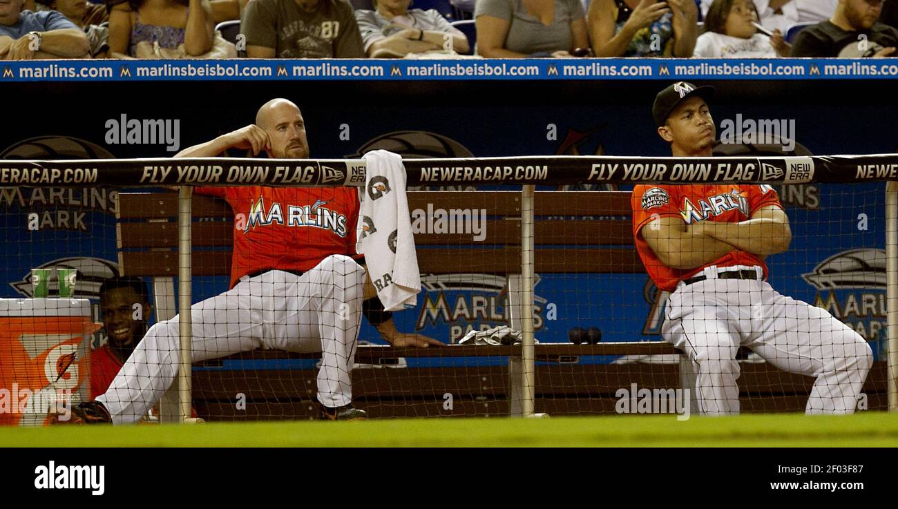 John Buck and Giancarlo Stanton of the Miami Marlins watch the action ...