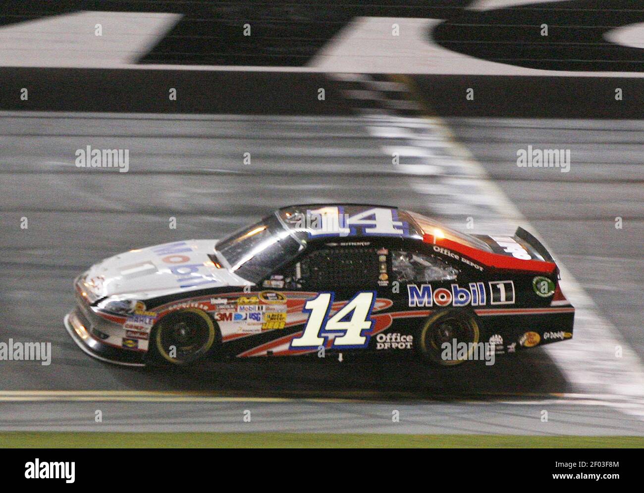Tony Stewart crosses the finish line to win the Coke Zero 400 NASCAR ...