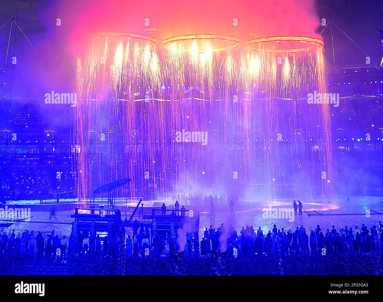 The Olympic rings shower sparks over the stage during the Opening ...