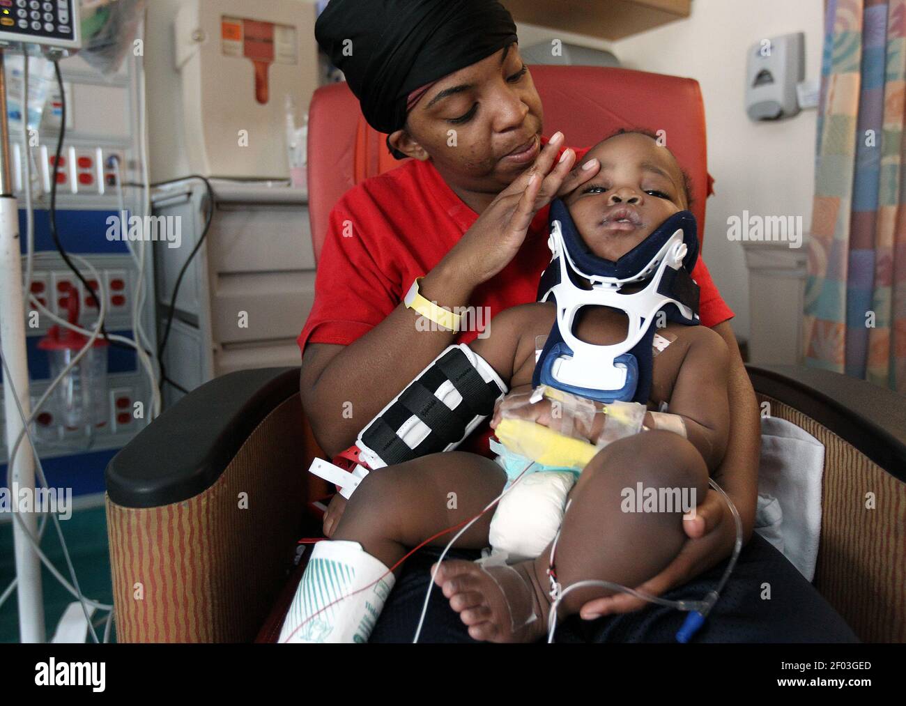 Tiesha Powell holds her son, Kyan, 10 mos., Wednesday, July 18, 2012 ...
