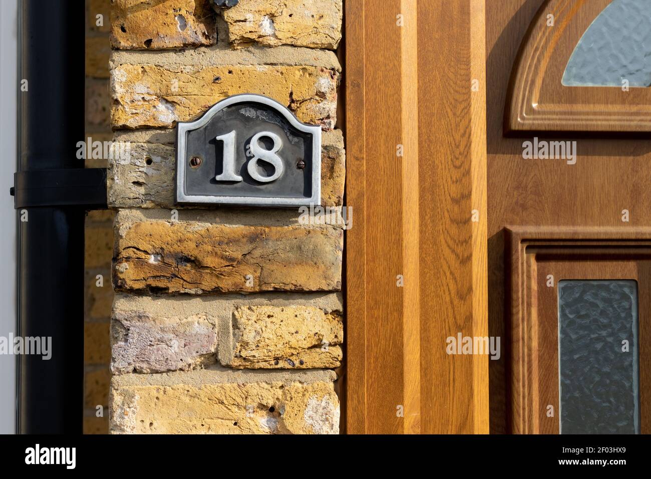 House number 18 in the sunshine Stock Photo - Alamy