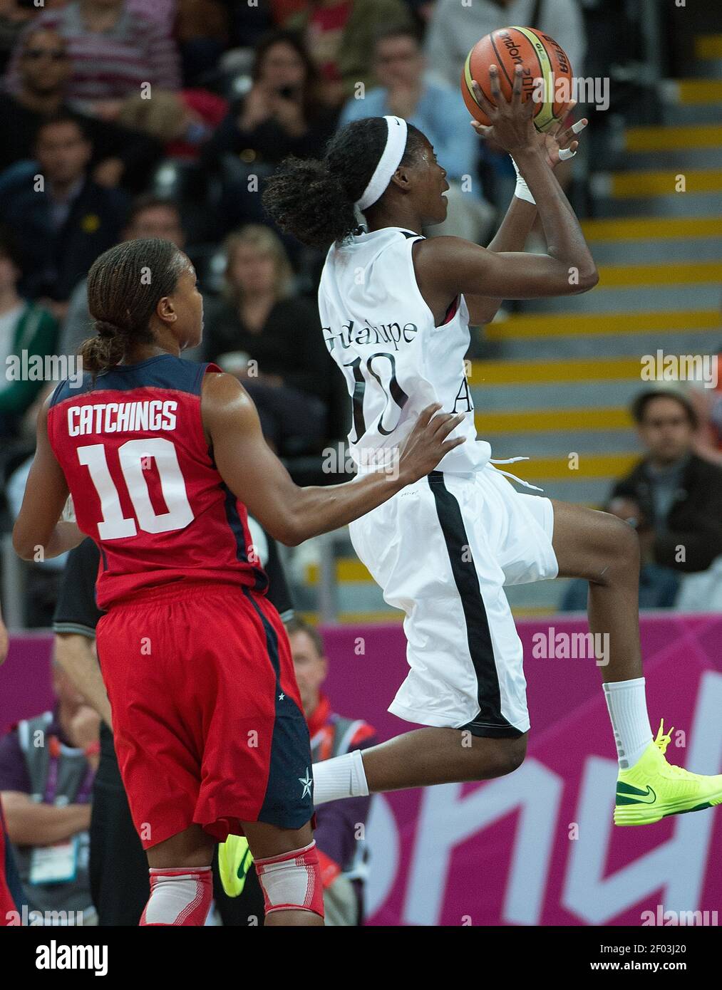Angola's Sonia Guadalupe (10) scores over Tamika Catchings (10) during ...