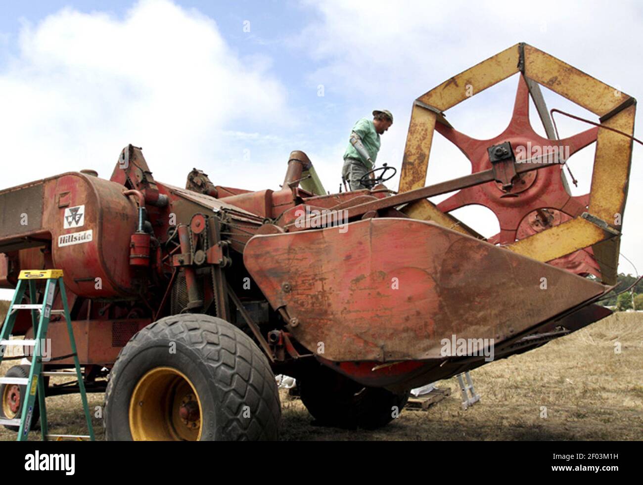 Ken Kimes stands atop a combine harvester in Pascadero, California ...