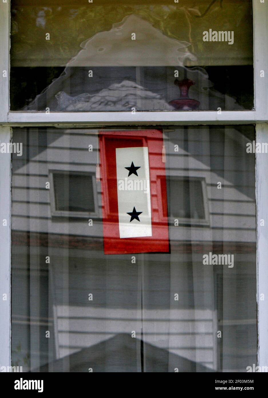 A Blue Star Banner is seen in a window in an Akron neighborhood. The ...