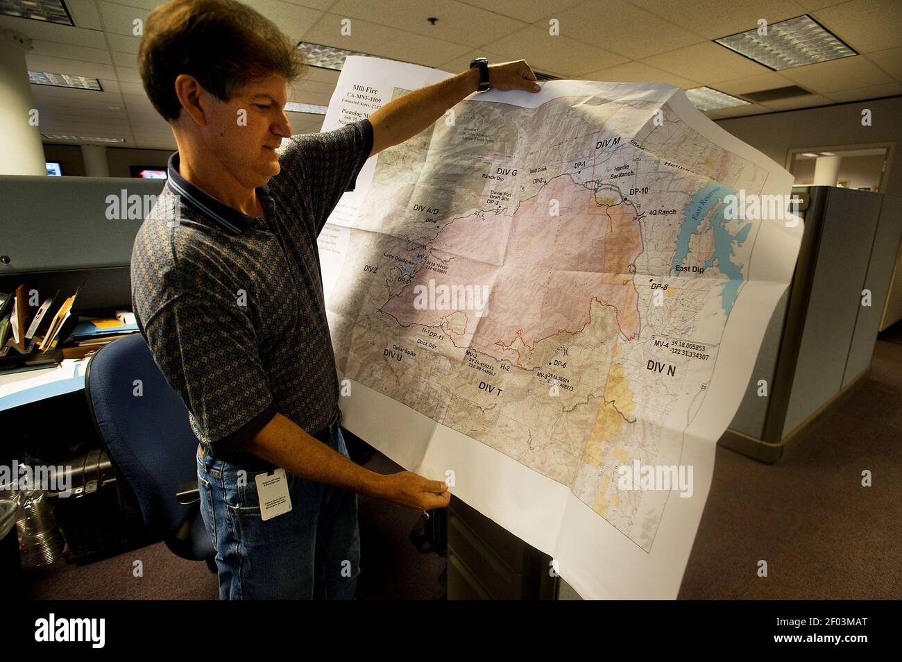 National Weather Service Meteorologist Mike Smith examines a map in his ...