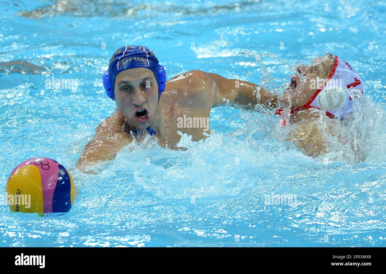 Serbia's Andrija Prlainovic (11), right, battles for the ball with ...
