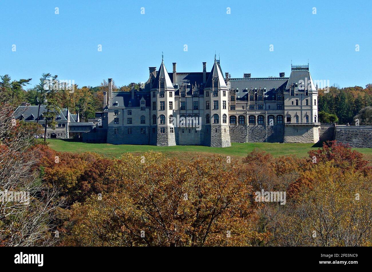 A view can be seen of the back of the Biltmore mansion from a horseback ...