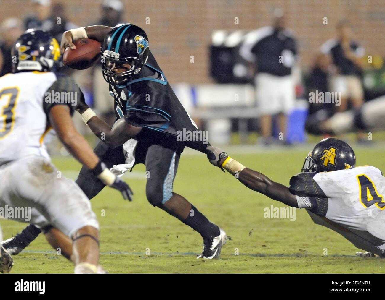 Coastal Carolina quarterback, Aramis Hillary is caught by the shirttail ...