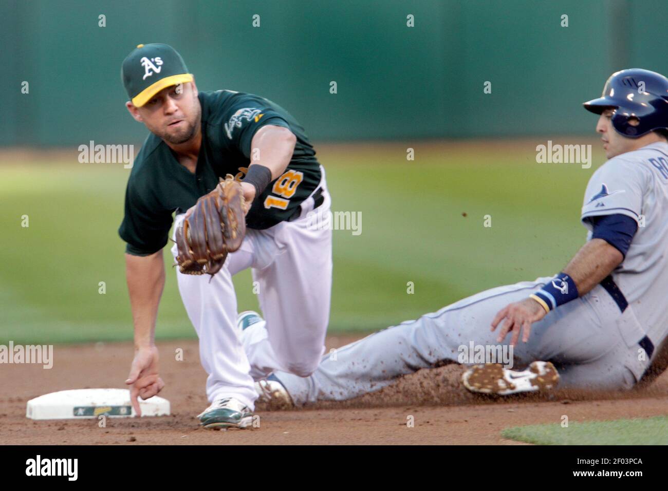 The Oakland Athletics' Brandon Hicks (18) stretches for a throw as the ...