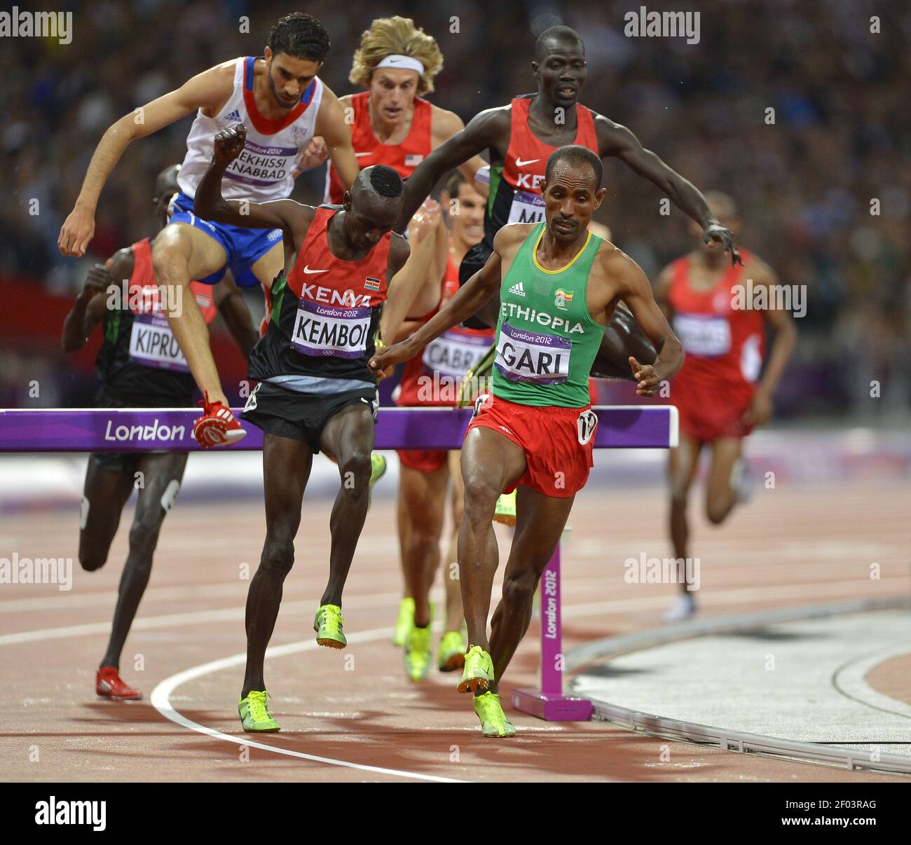 Ezekiel Kemboi of Kenya, center, moves to the lead in the final stretch ...