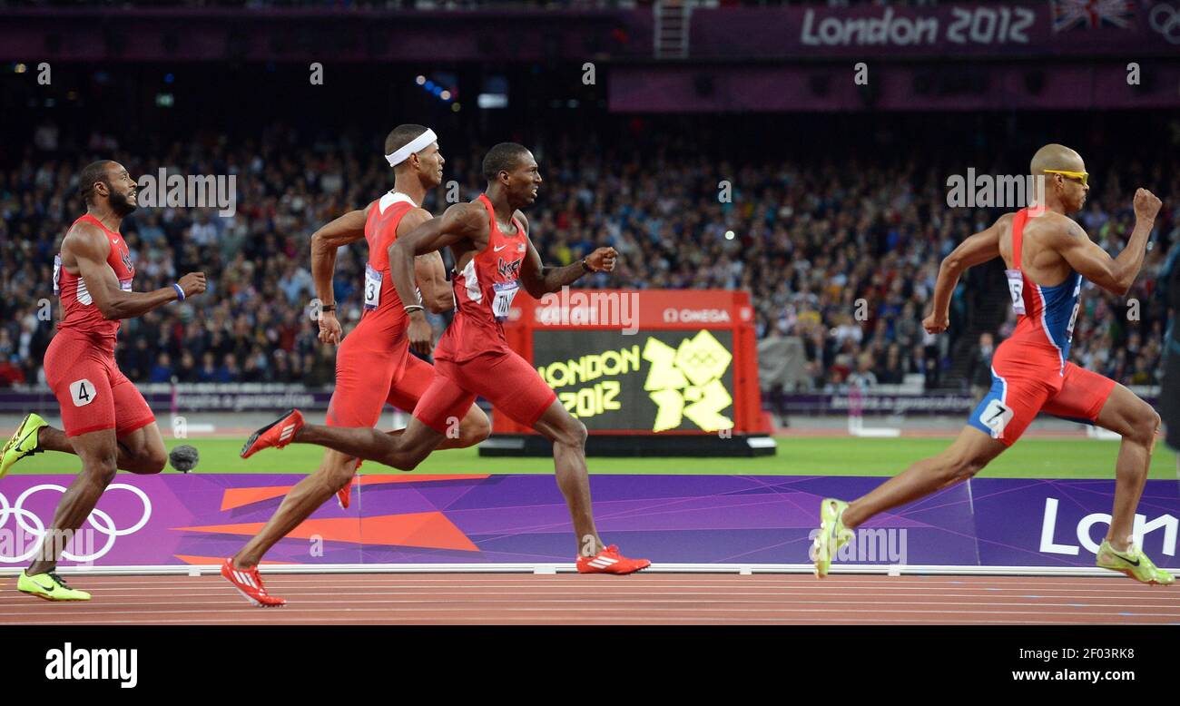 Felix Sanchez, right, of the Dominican Republic drives to the finish ...