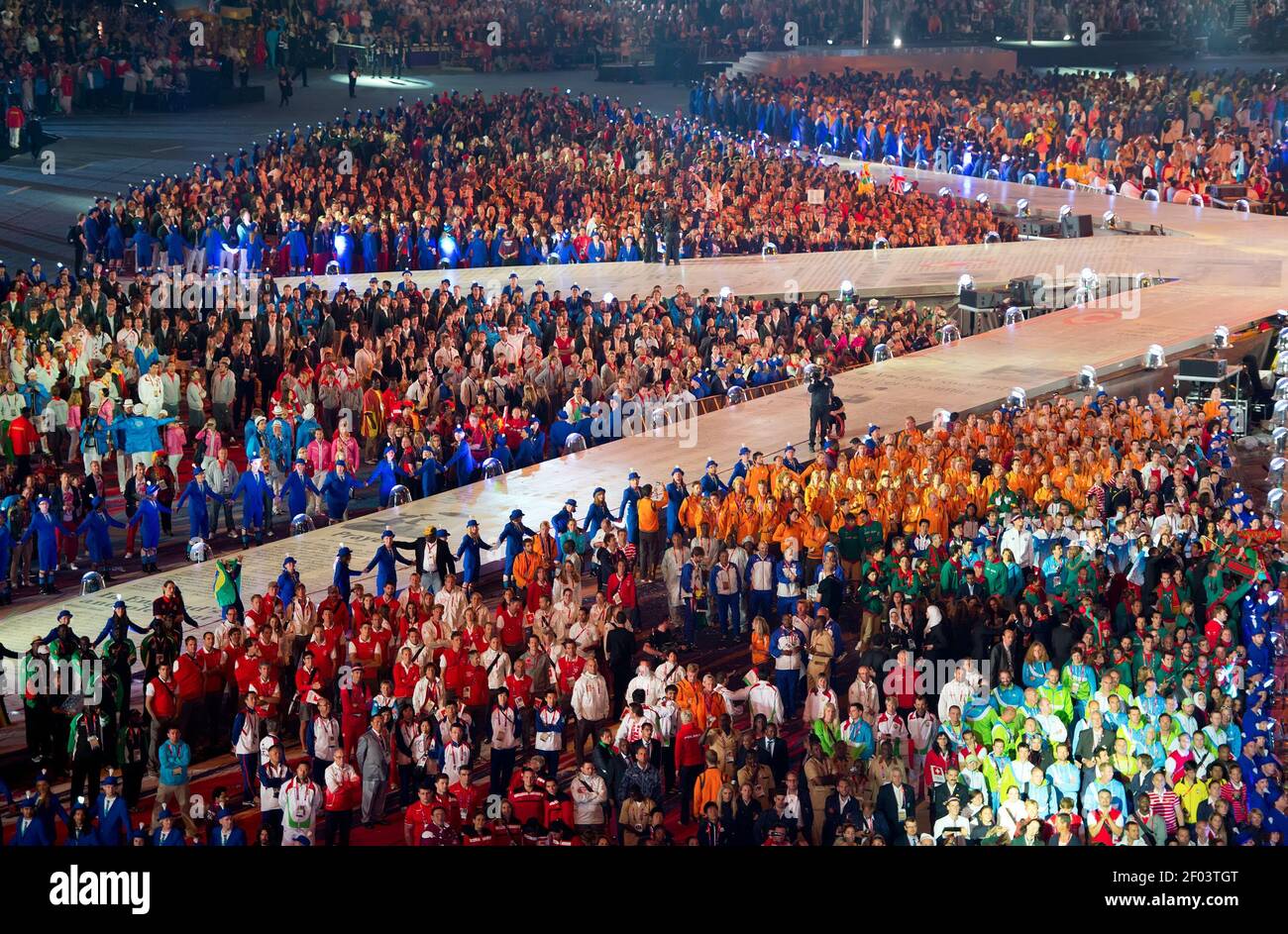 Athletes of the nations competing at the Olympics stand in groups ...