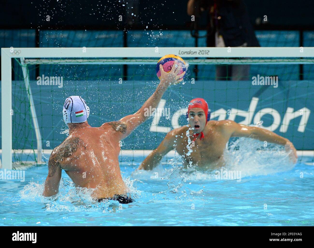 Hungary's Peter Biros (10) scores against USA goalkeeper Merrill Moses ...