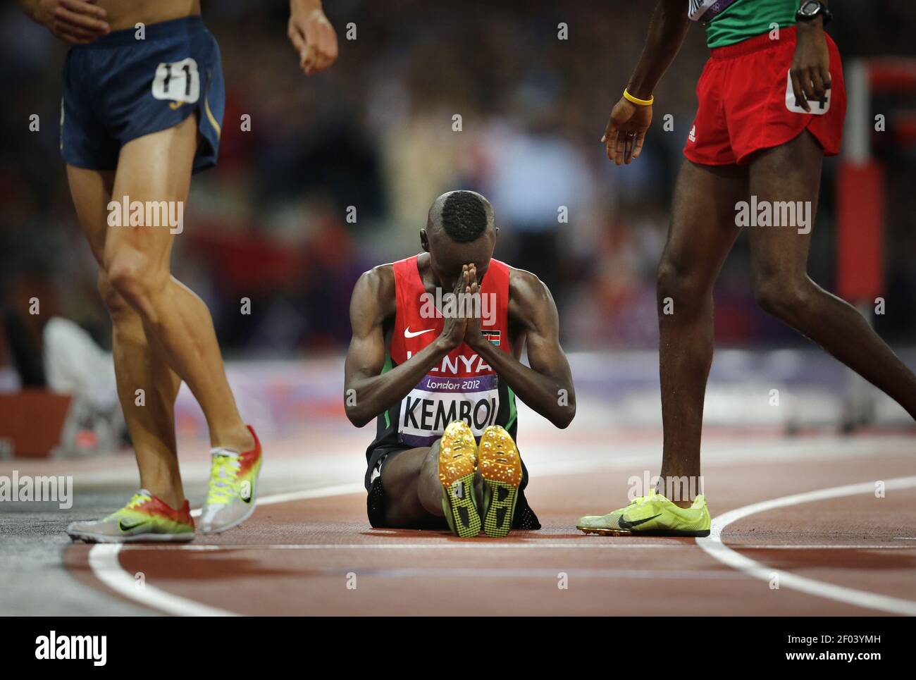 Kenya's Ezekiel Kemboi says a prayer on the track after winning the men ...