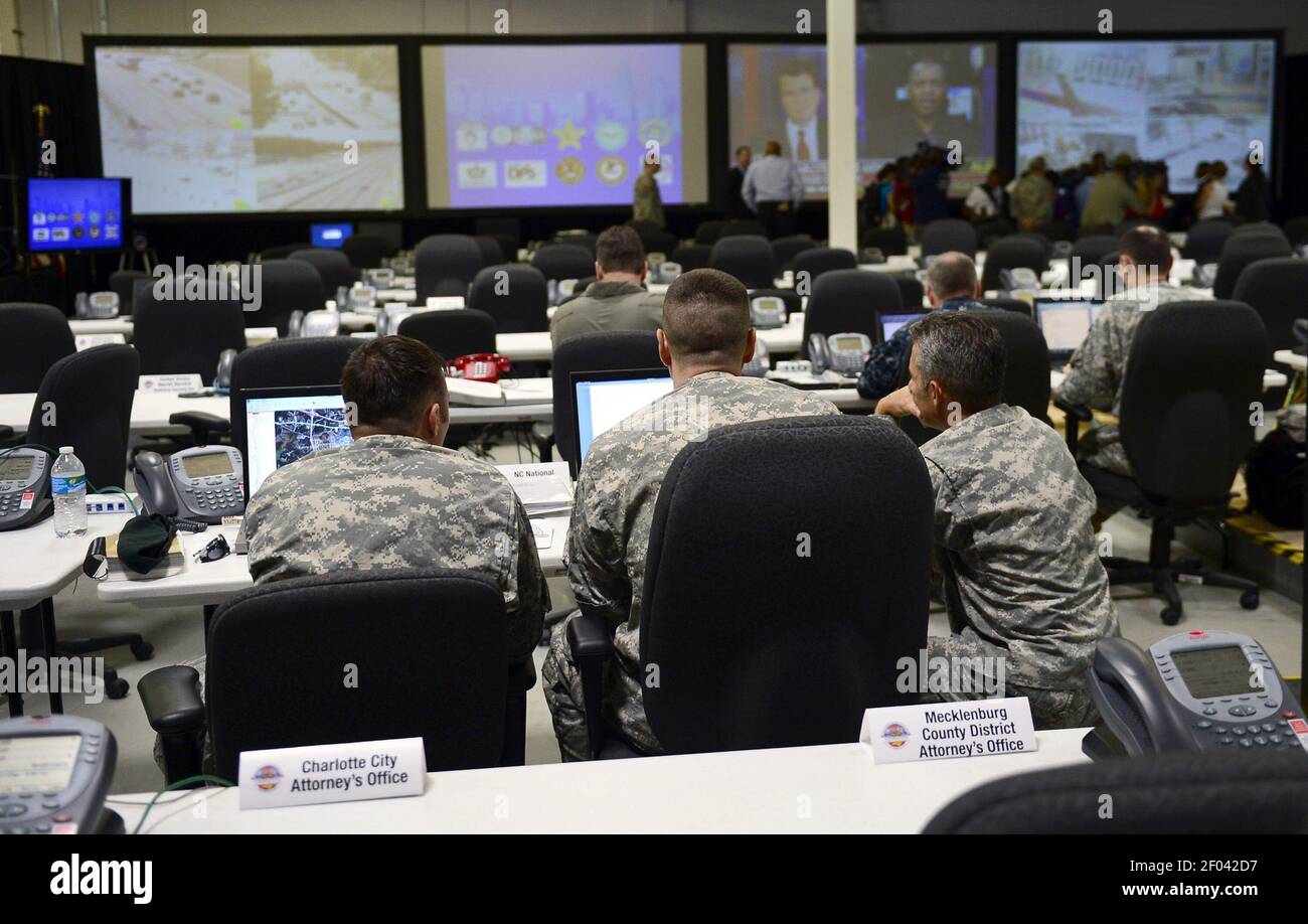 Military personnel work inside the Multi-Agency Communication Center in ...