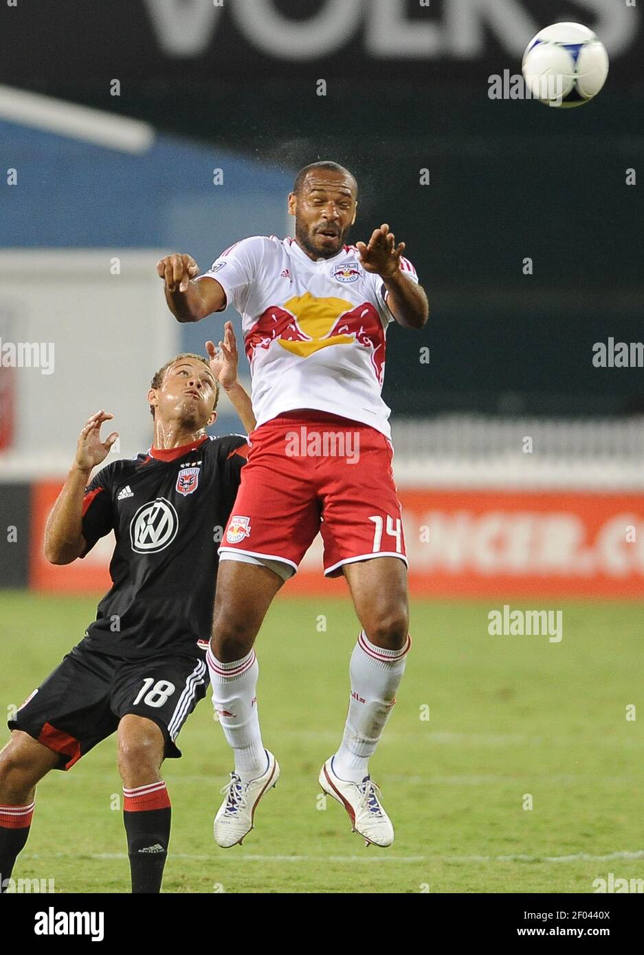 New York Red Bulls forward Thierry Henry (14) heads the ball forward over D.C. United midfielder ...