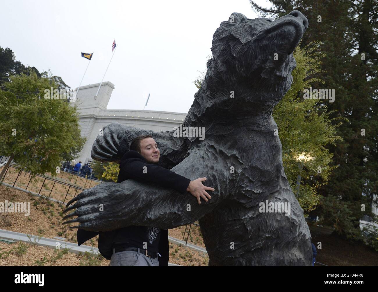 Eric Felder gives a bear statue in front of Memorial Stadium a big hug before attending the ...