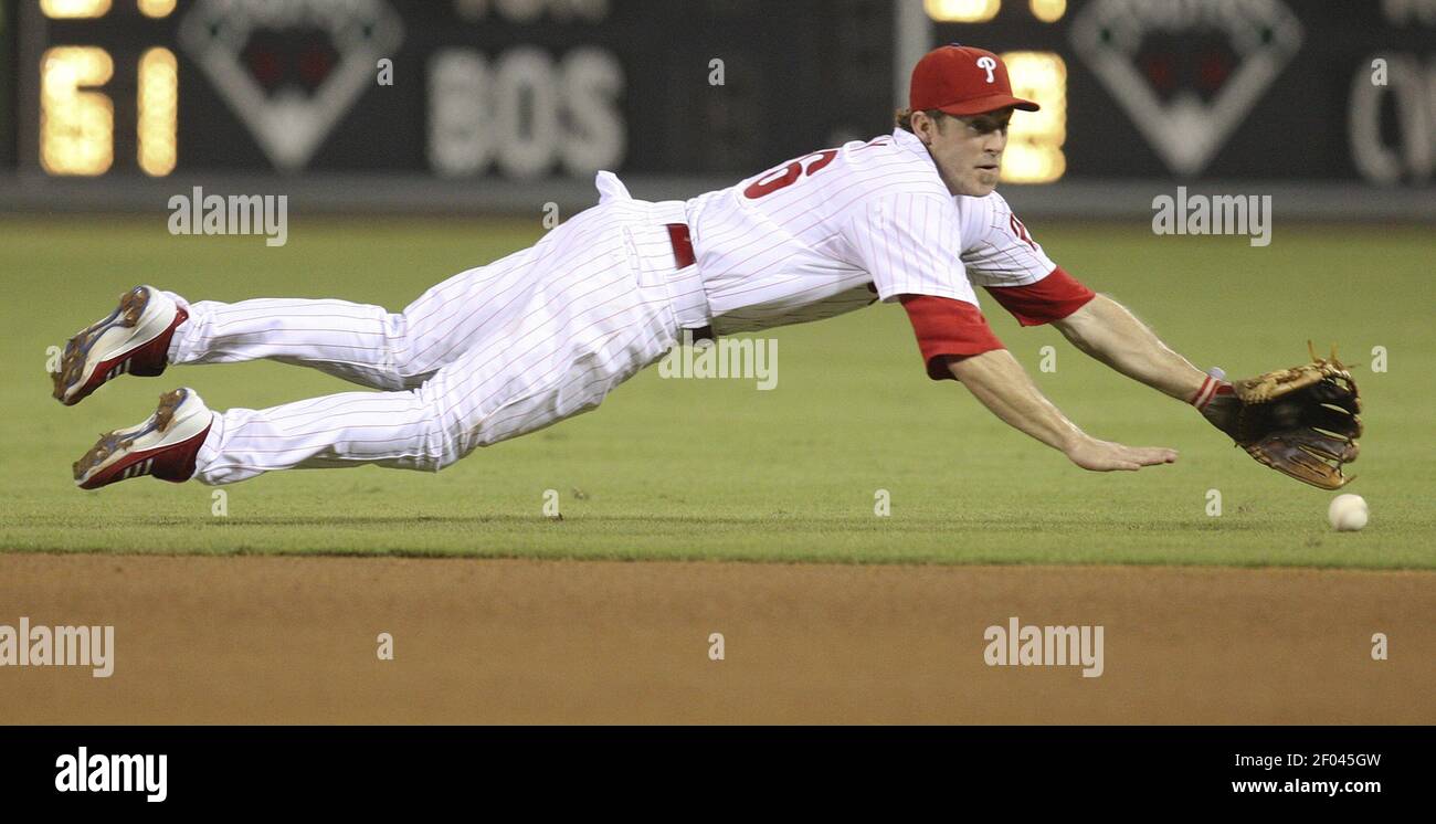 Philadelphia Phillies second baseman Chase Utley can't get a glove on ...