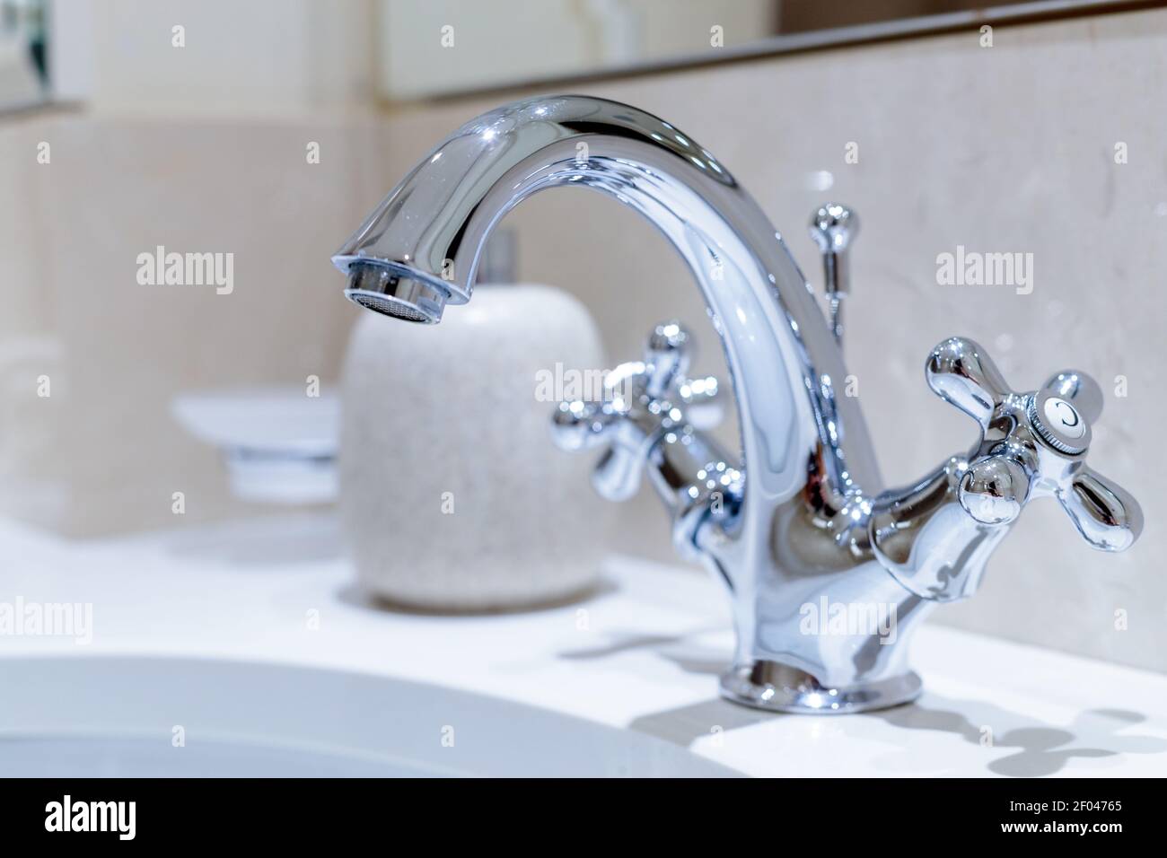 A closeup shot of a silver faucet in the bathroom Stock Photo - Alamy