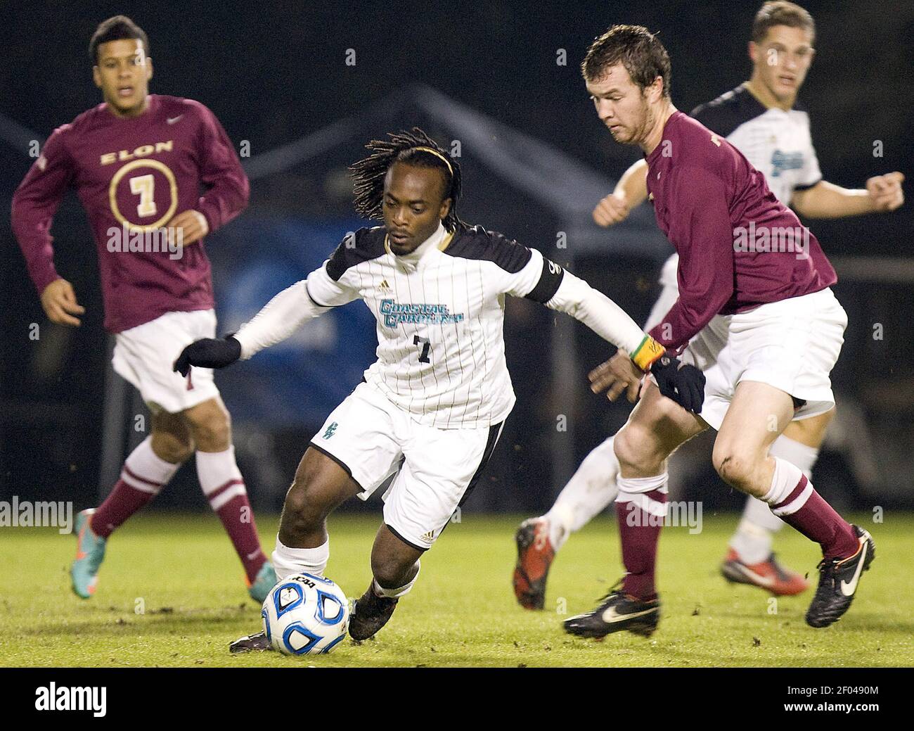 Coastal Carolina University's Ashton Bennett (7) works the ball against Elon defenders during a ...