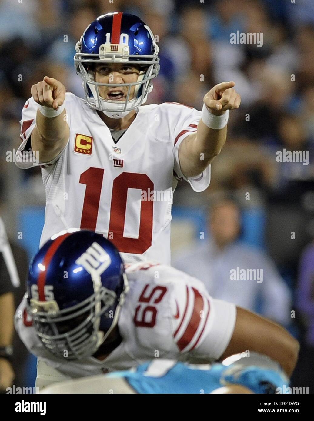 New York Giants quarterback Eli Manning looks over the line and calls a ...