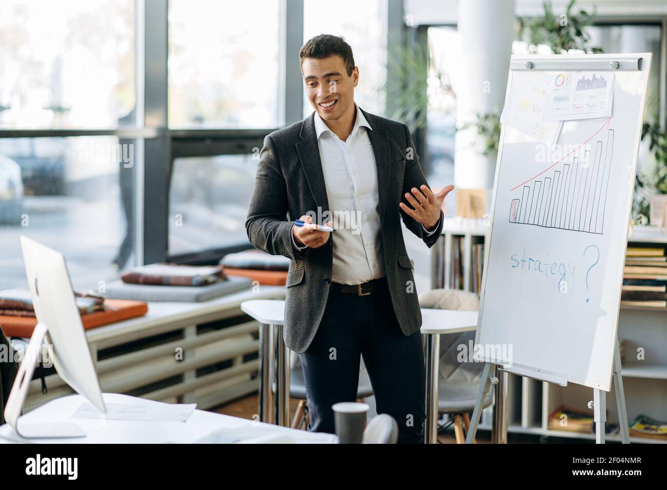 Friendly successful male manager making presentation, submit report by ...