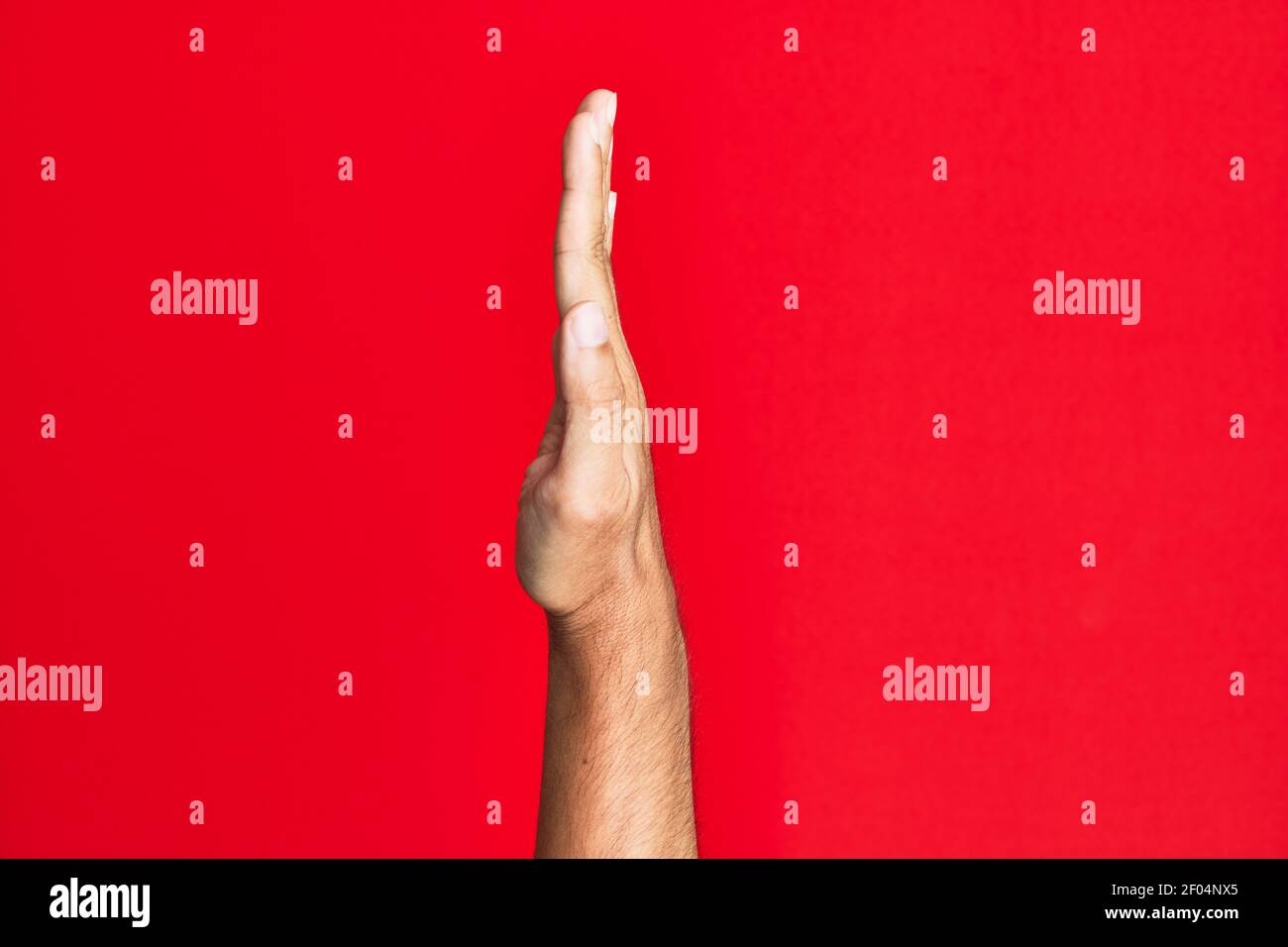 Arm of caucasian white young man over red isolated background showing ...