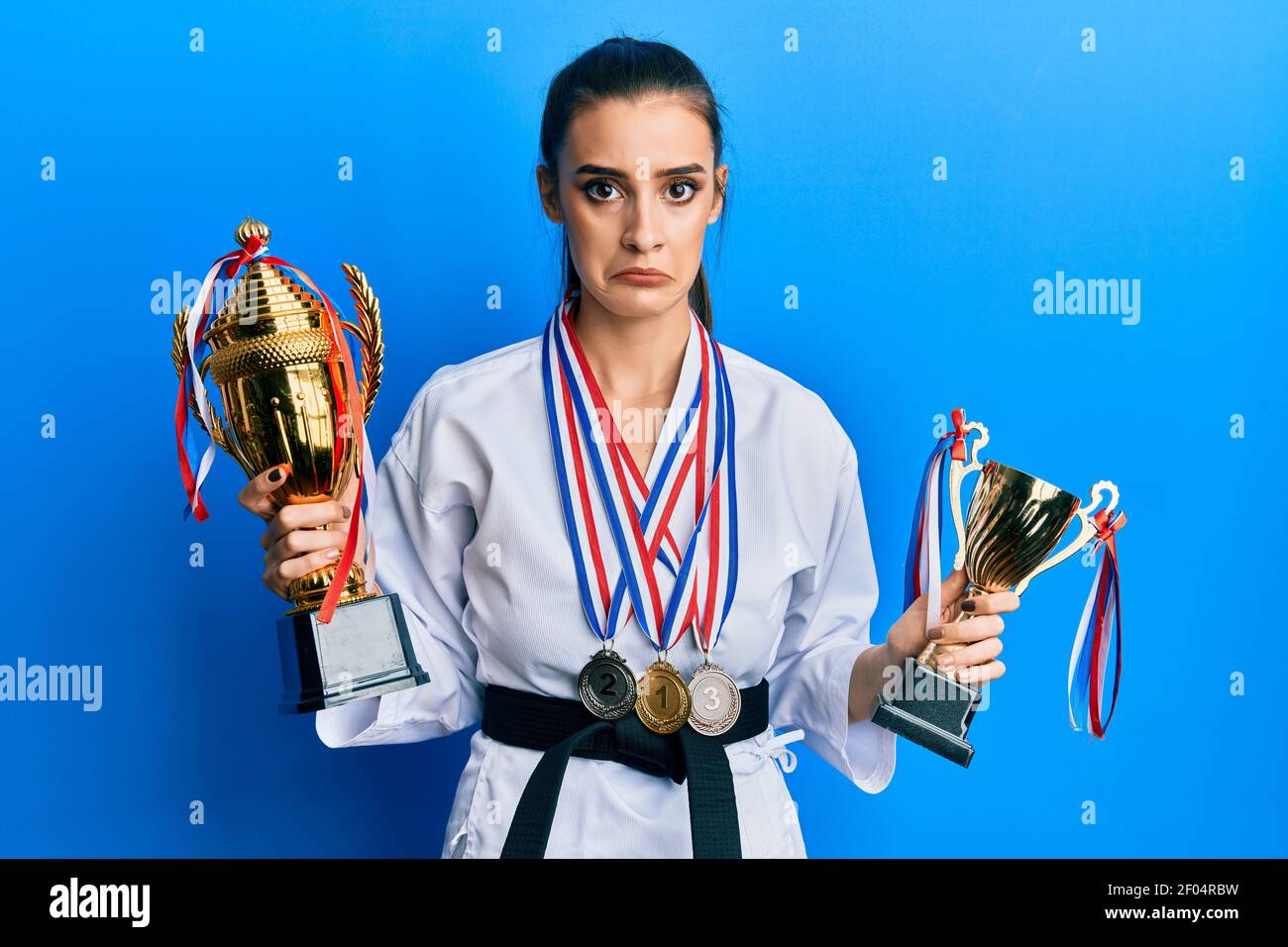 Beautiful brunette young woman wearing karate fighter uniform and ...