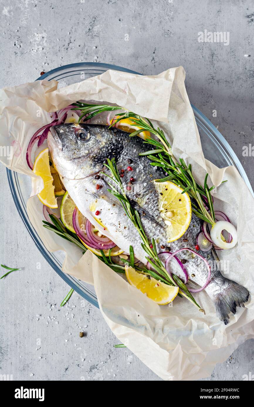 Fresh fish dorado. Raw dorado with herbs, spices and lemon and lime ...