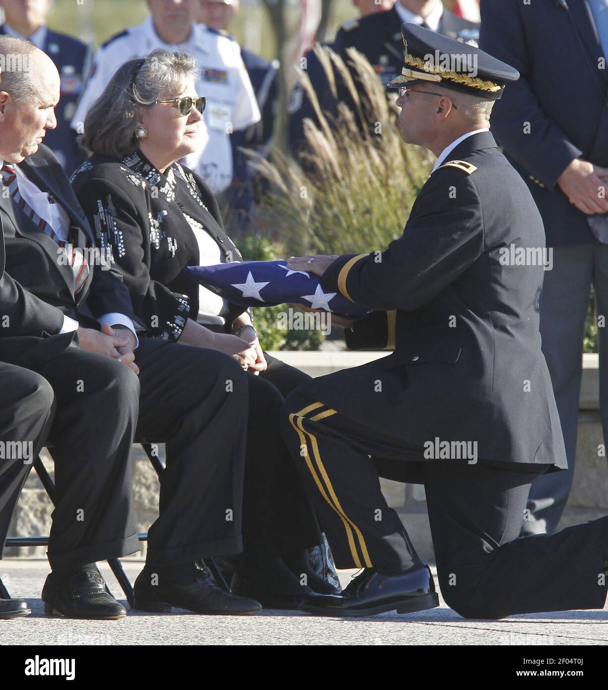 Maj. General Anthony Ierardi of Fort Hood presents a folded U.S. flag ...