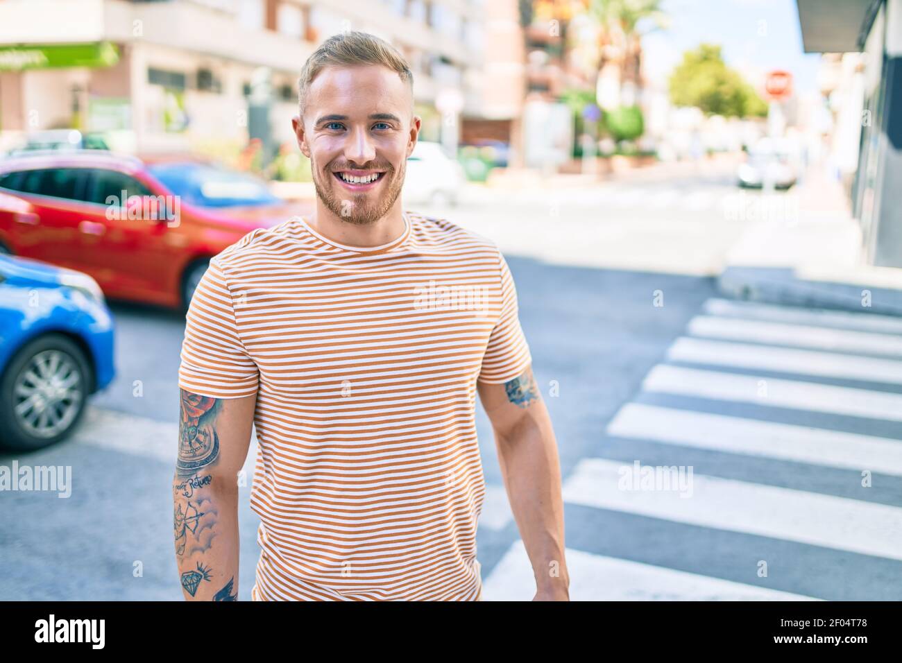 Young irish man smiling happy walking at street of city Stock Photo - Alamy