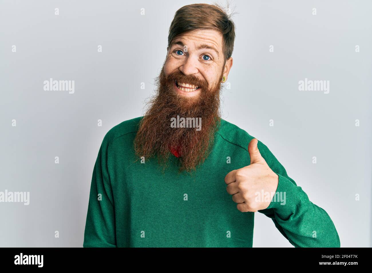 Redhead man with long beard wearing casual clothes doing happy thumbs ...