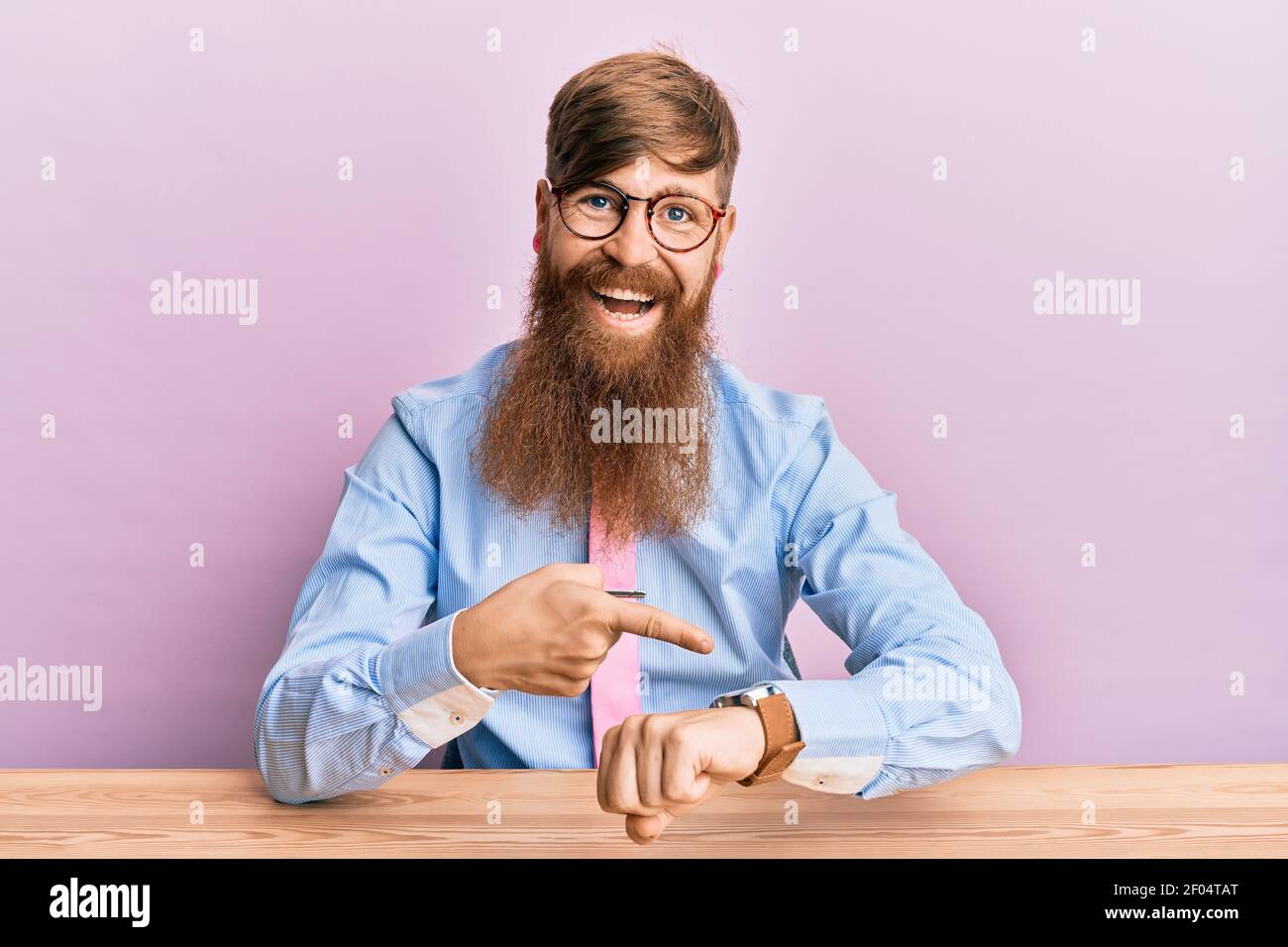 Young irish redhead man wearing business shirt and tie sitting on the ...