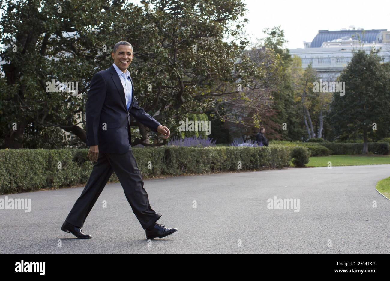 President Barack Obama walks across the South Lawn of the White House ...