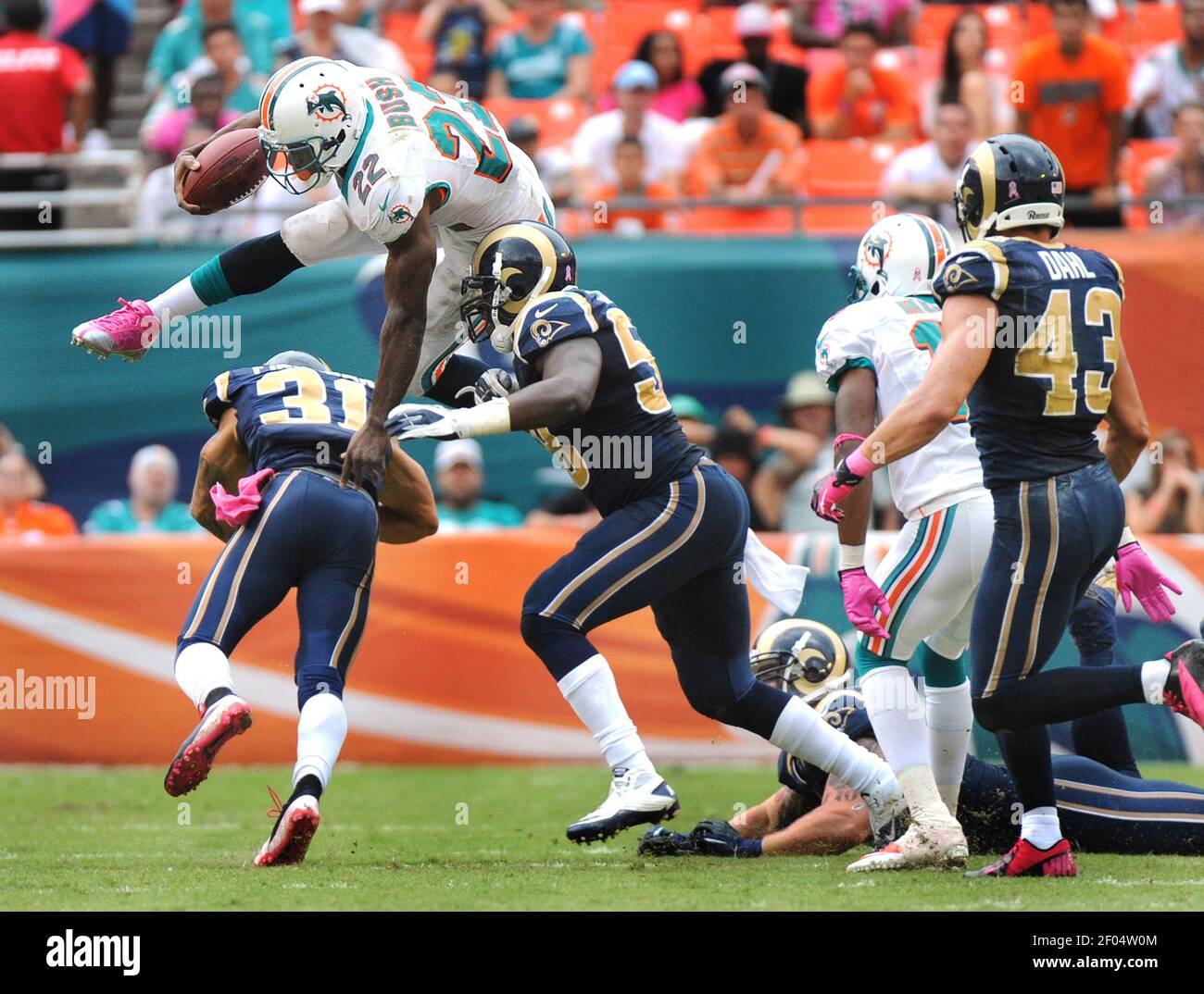 Miami Dolphins running back Reggie Bush (22) leaps over St. Louis Rams ...