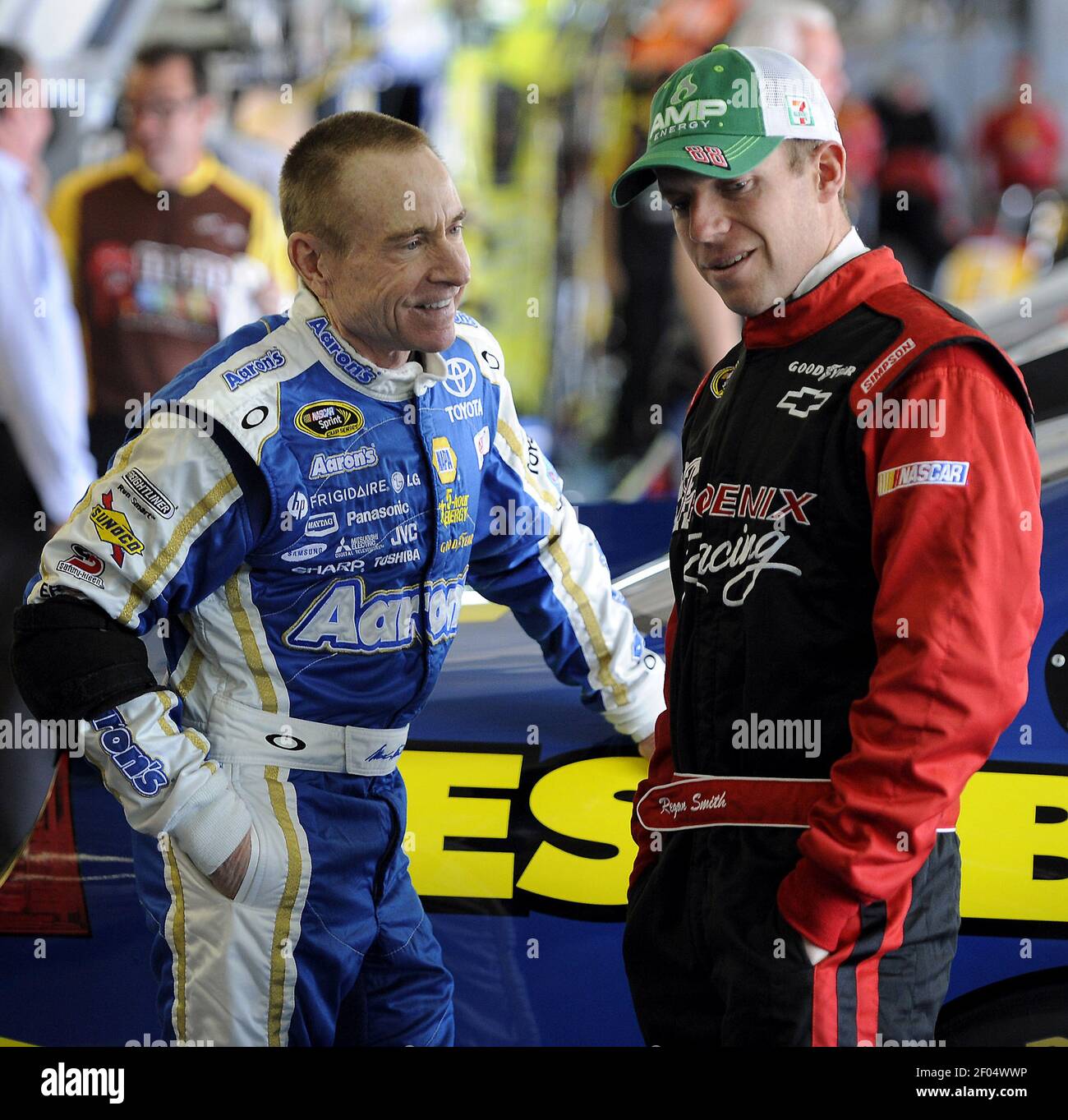 NASCAR drivers Mark Martin, left, and Regan Smith talk in the garage on ...