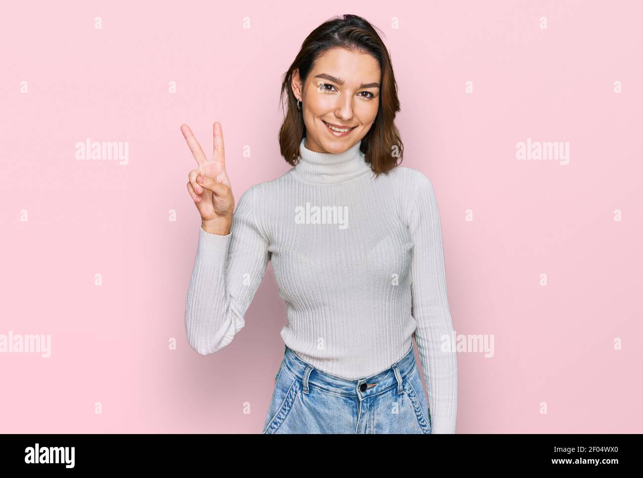 Young caucasian girl wearing casual clothes showing and pointing up ...