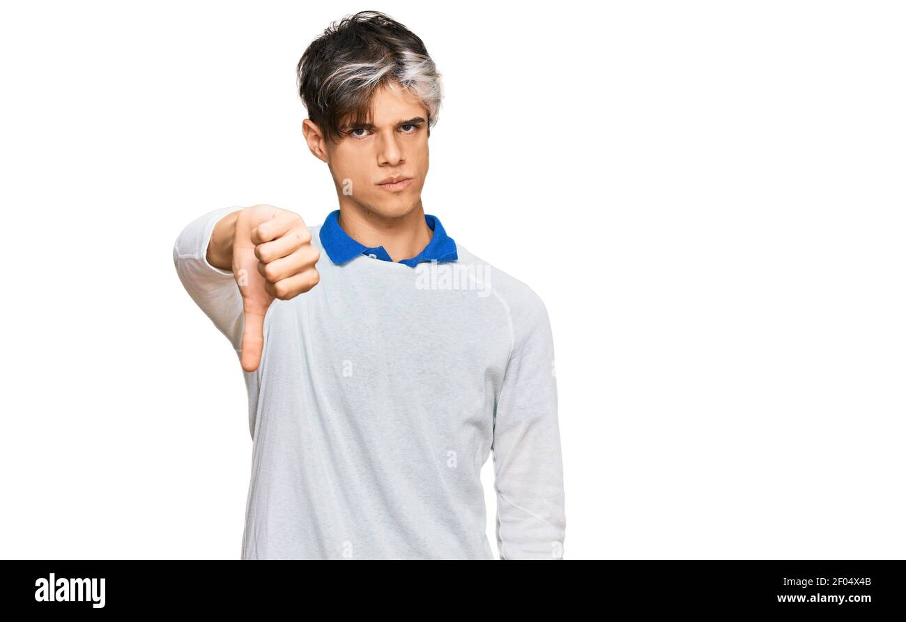 Young hispanic man wearing casual clothes looking unhappy and angry ...