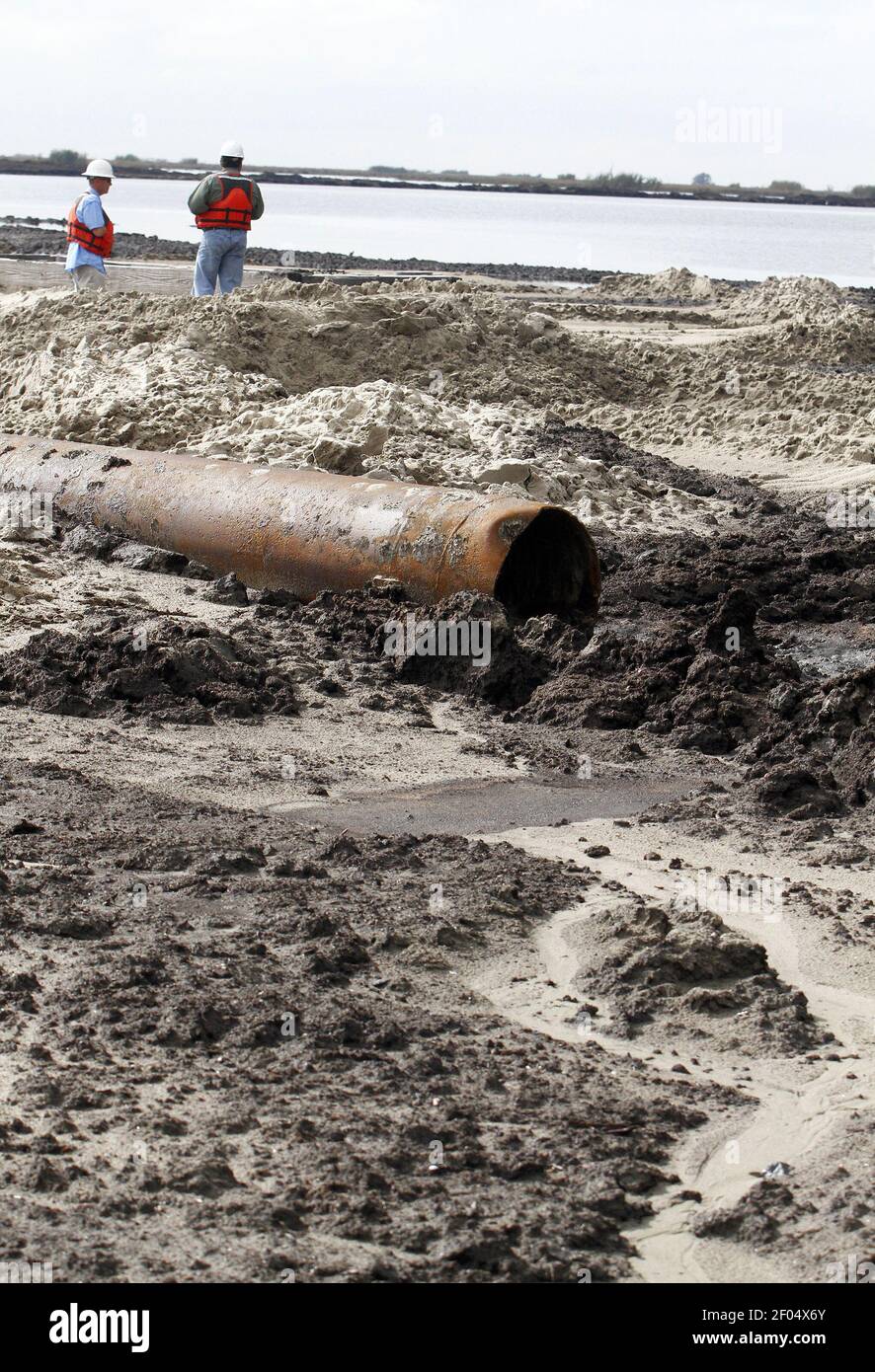 Construction workers look at the progress of the Lake Hermitage Marsh ...